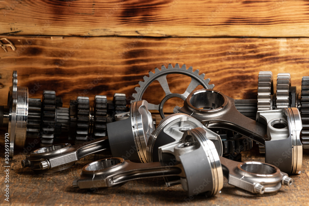 high performance motorcycle engine parts on a workbench. pistons ...