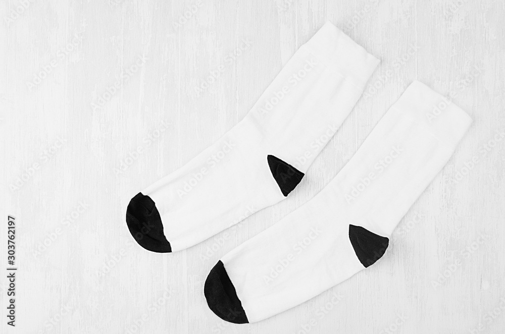 Pair blank white tall socks with black heel flat lay on white wood ...