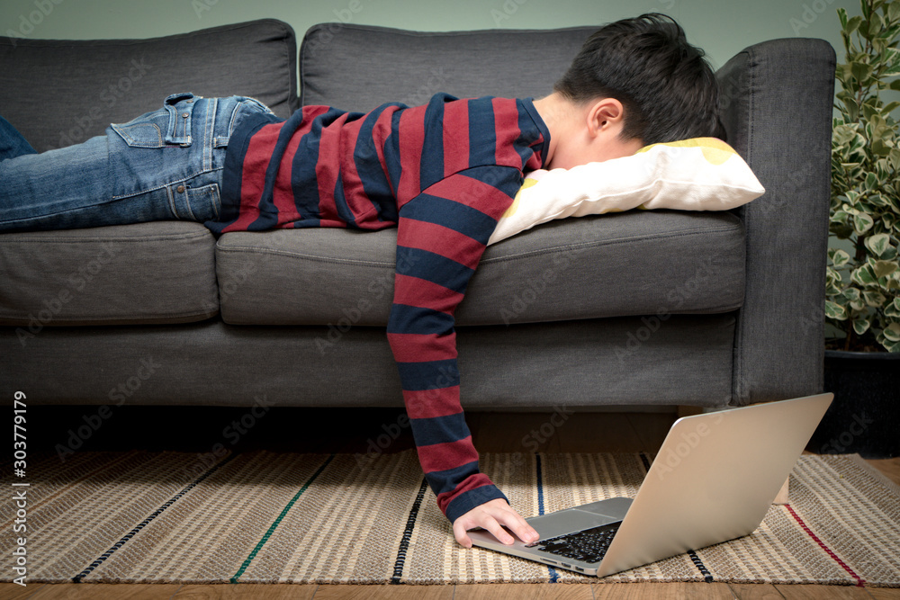 An asian smart looking preteen - teenager boy lying face down ...