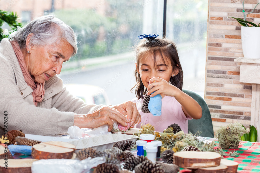 Little girl having fun while making christmas Nativity crafts with her ...