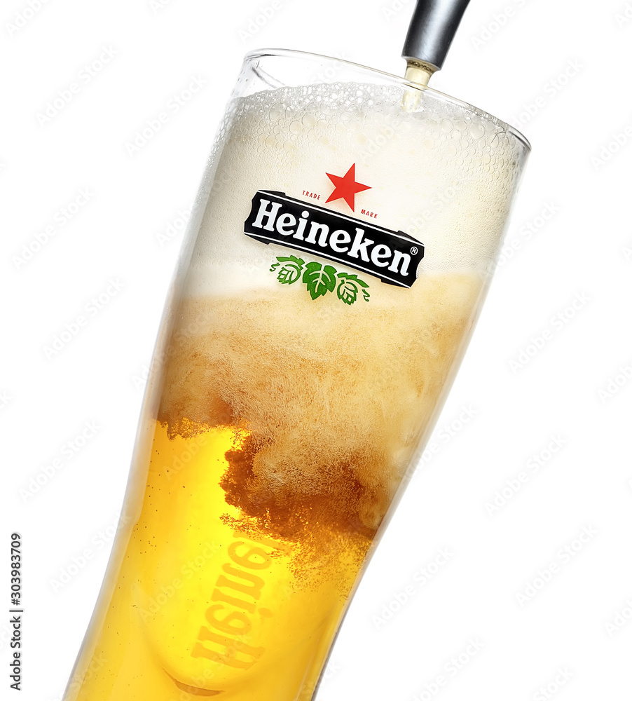 POLTAVA, UKRAINE - MARCH 22, 2018:Heineken beer is pouring into a glass ...