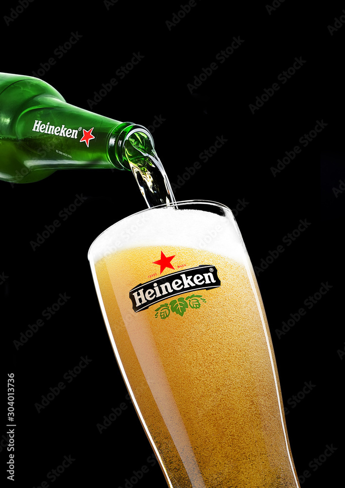POLTAVA, UKRAINE - June 18, 2018:Heineken beer is pouring into a glass ...