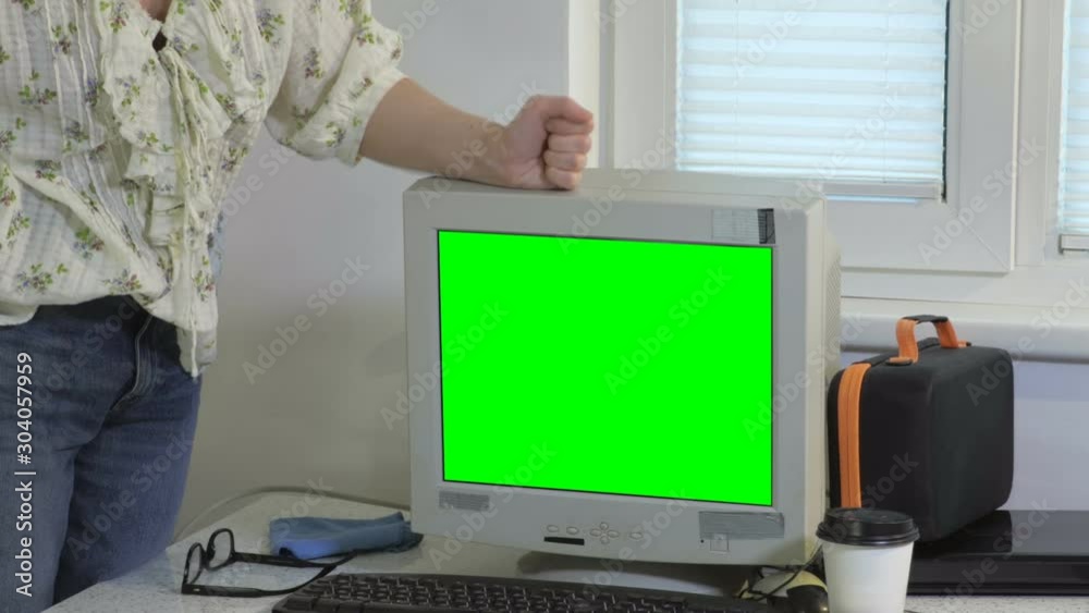 Woman trying to repair broken computer Monitor with hitting.Green ...