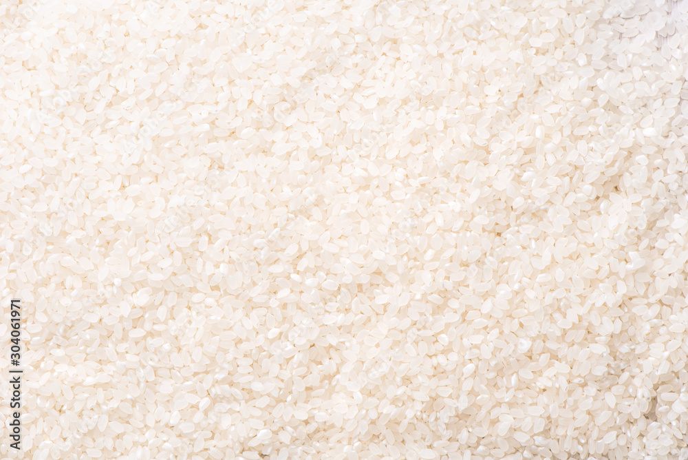 Raw white polished milled edible rice crop on white background in brown ...