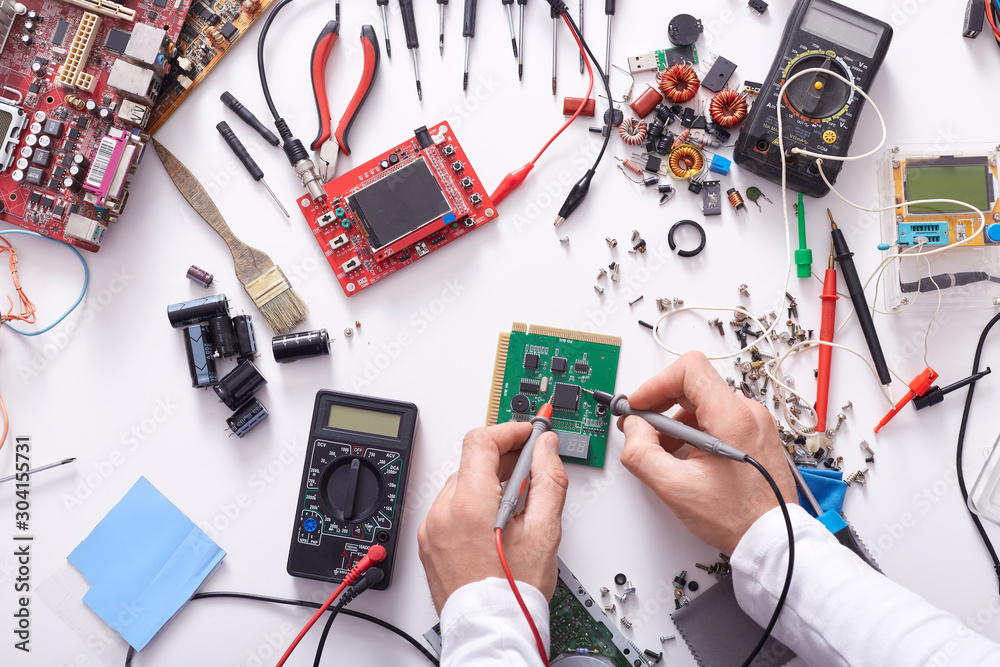 Faceless portrait of radioman testing electric current in circuit board ...