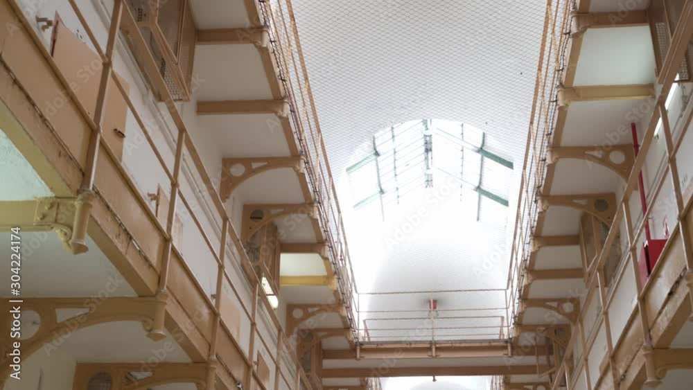 metal balcony in the prison corridor with the doors of the prison cells ...