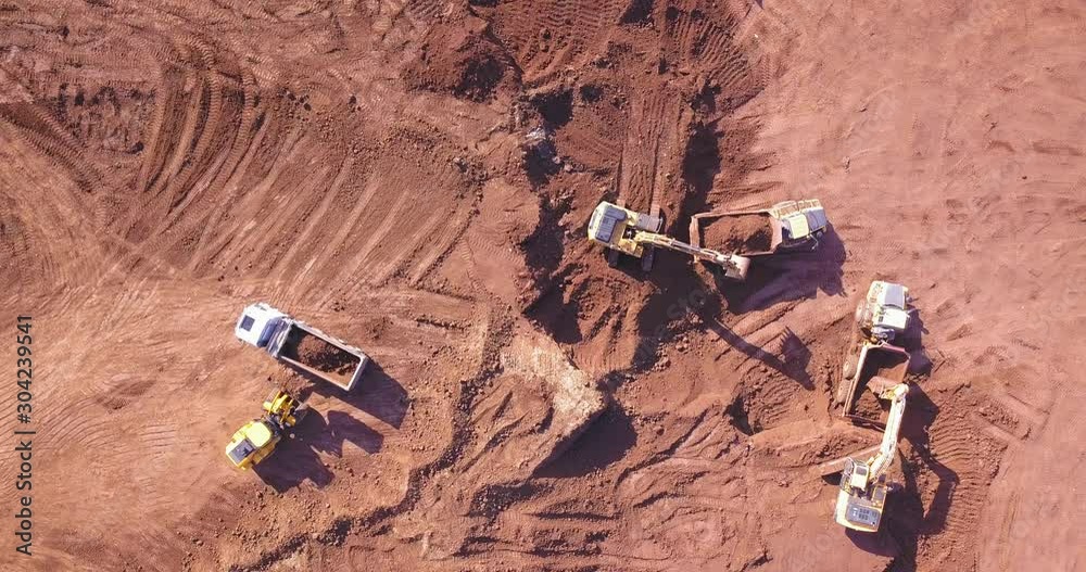 Top down view of several excavators working on a construction site ...