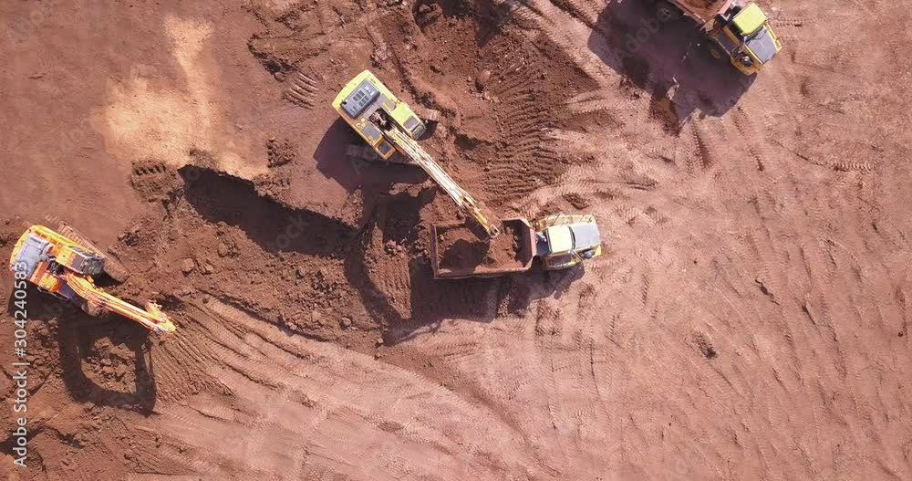 Top down view of several excavators working on a construction site ...