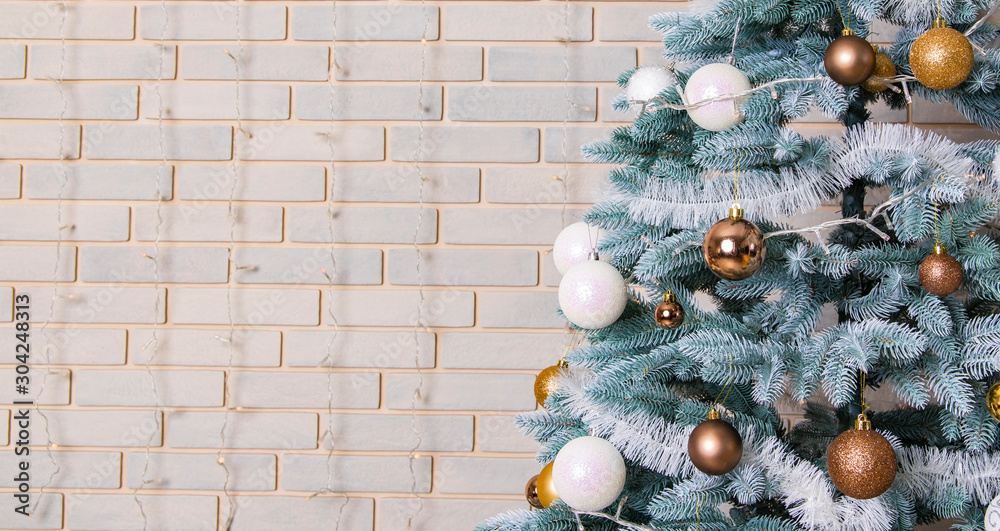 Christmas tree toys brick wall background space with garland yellow ...