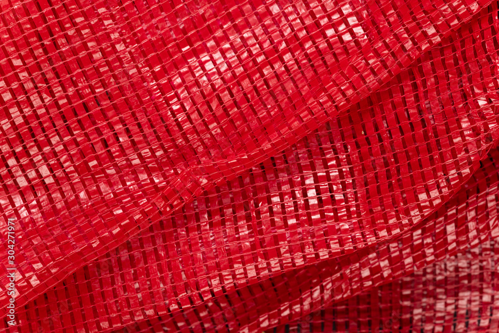 Red woven plastic net for packaging fruits, vegetables, or products ...
