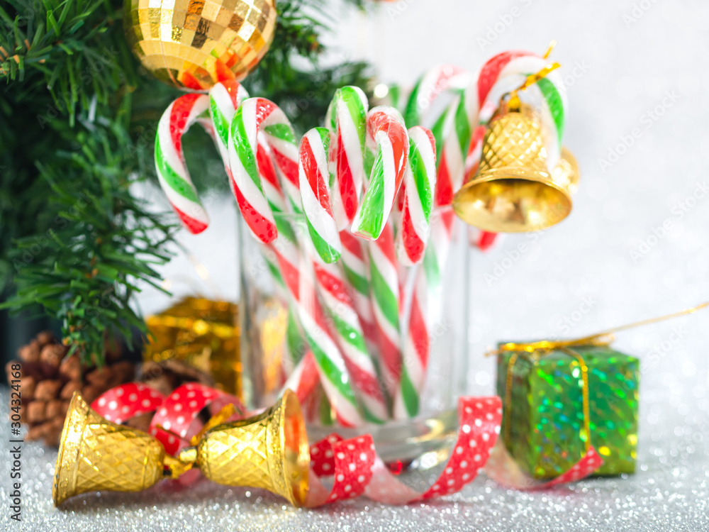 Christmas candy sticks on glass with silver bokeh background. Stock ...