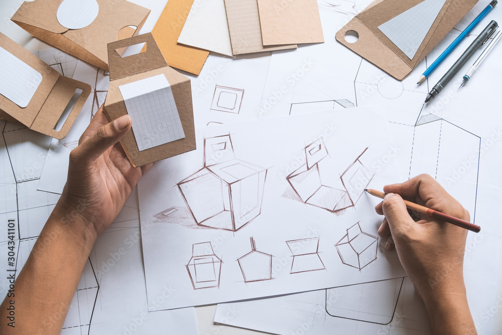 Designer sketching drawing design Brown craft cardboard paper product ...
