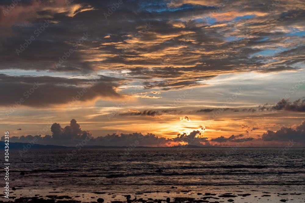 Amazing Sunset/Sunrise view with dramatic clouds in the sky, at coastal ...