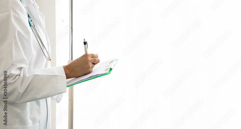 The doctor made a review of the patient charts. writing on a medical ...