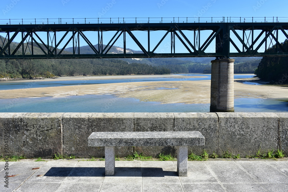Beach with forest and train bridge over Sor coastal river. Promenade ...