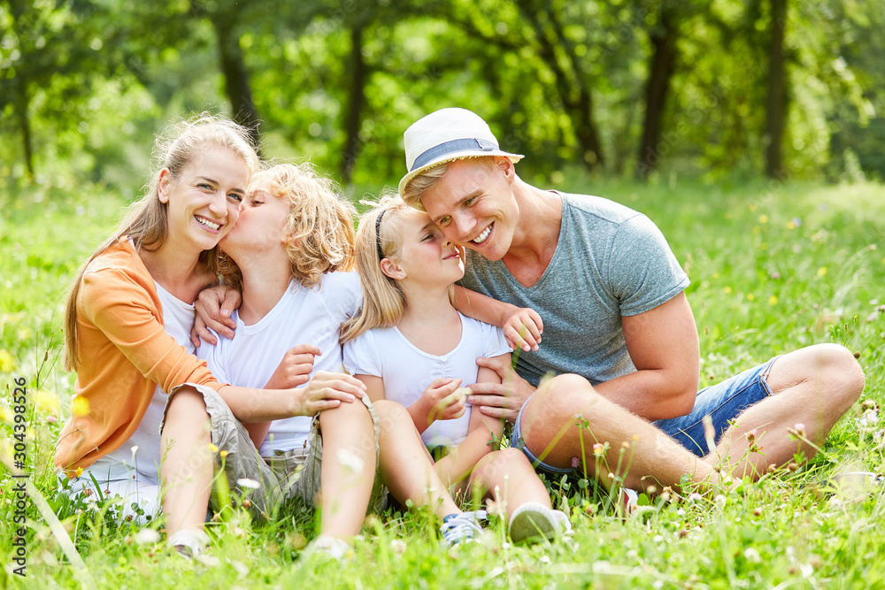 Happy family is sitting relaxed in the garden Stock Photo | Adobe Stock