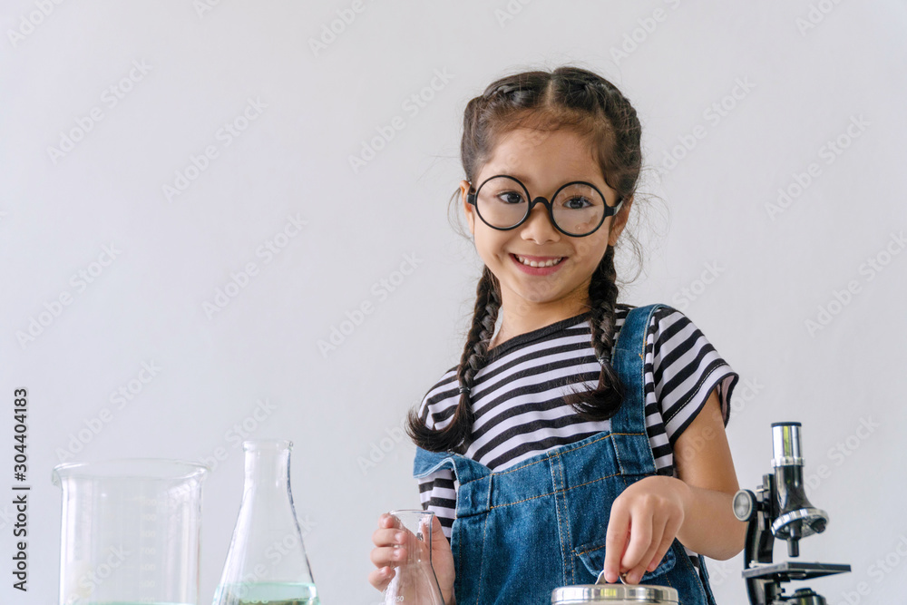 Little 6s cute girl smiling with microscope, laboratory bottle and ...