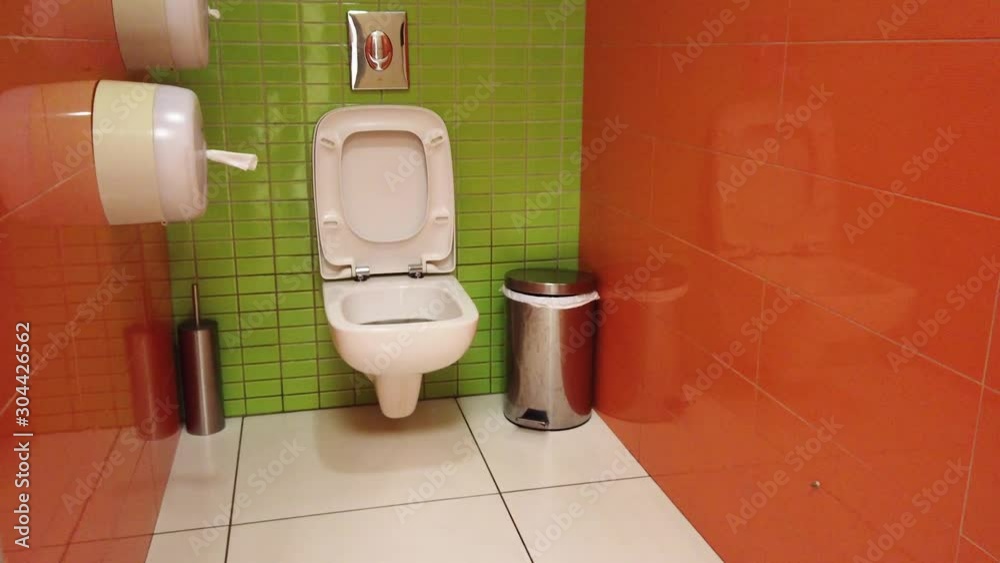 Point of view, first visitor perspective in a public restroom. Toilet ...