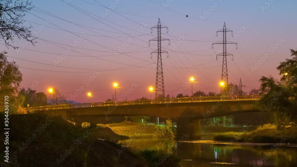 Tilt Up: Transmission towers, electricity pylons tower at sunset with ...
