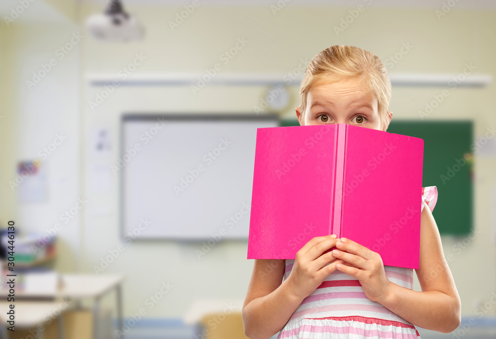 childhood and people concept - little girl hiding behind book over ...