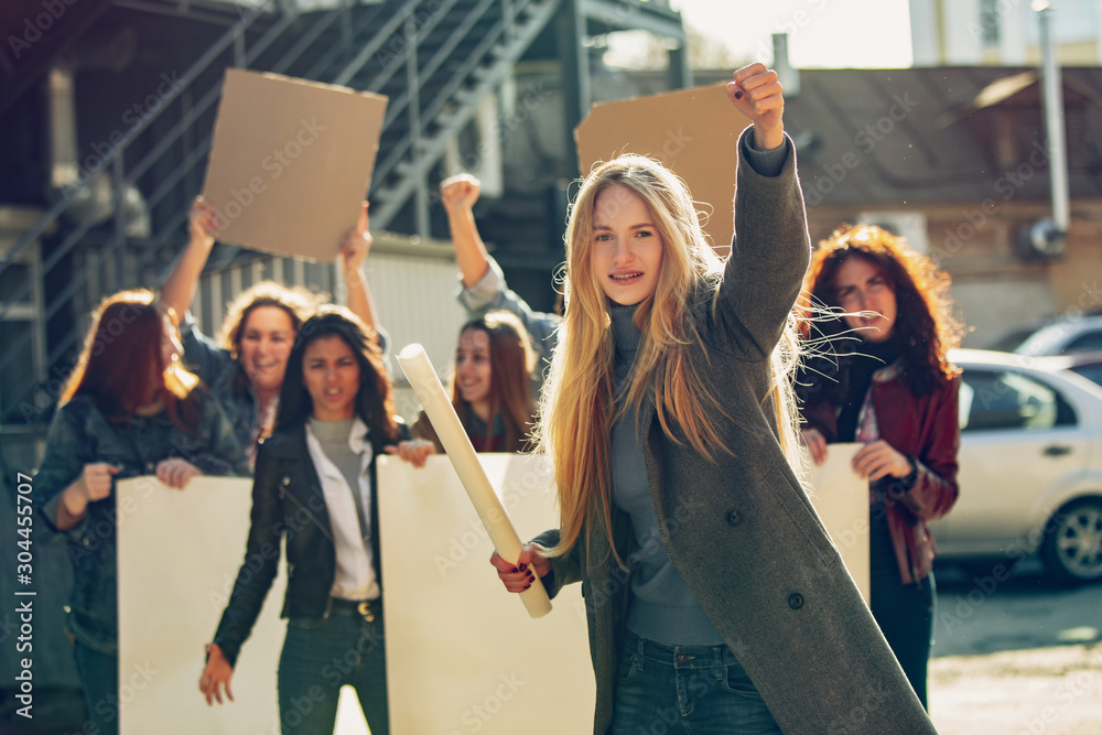 Young woman screaming in front of people protesting about women's ...