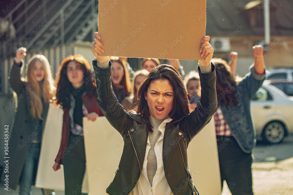 Young people protesting of women's rights and equality on the street ...