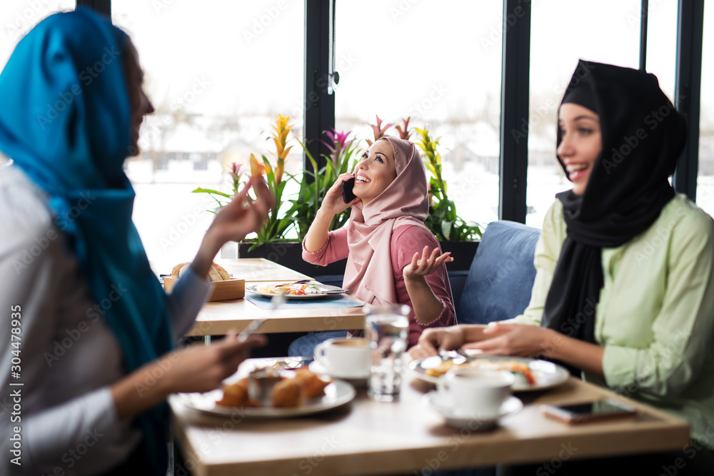 Young muslim woman in the restaurant Stock Photo | Adobe Stock