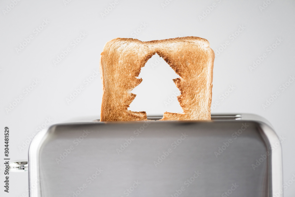 Hole in a form of christmas tree on roasted toast bread popping up of ...