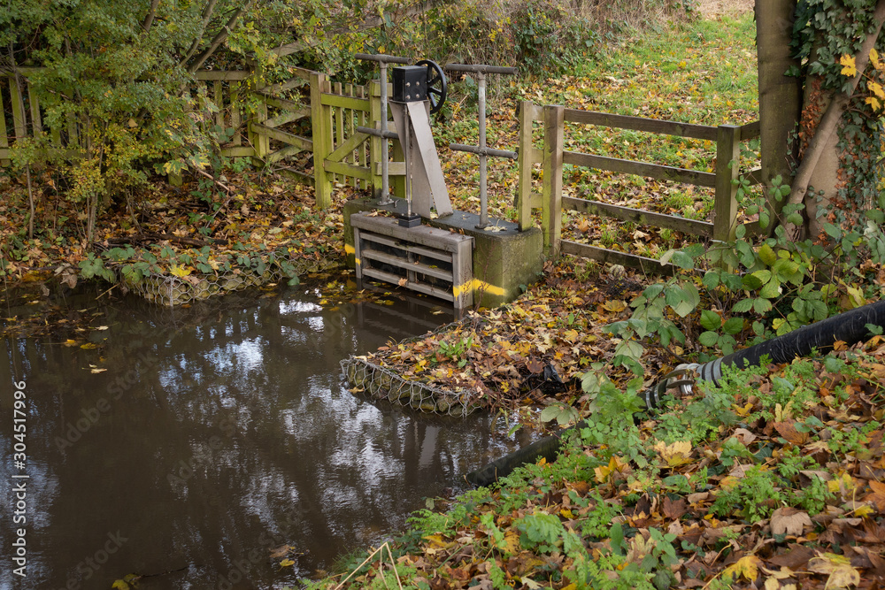 sluice gate closed to stop flood water backing up a tributary on the ...