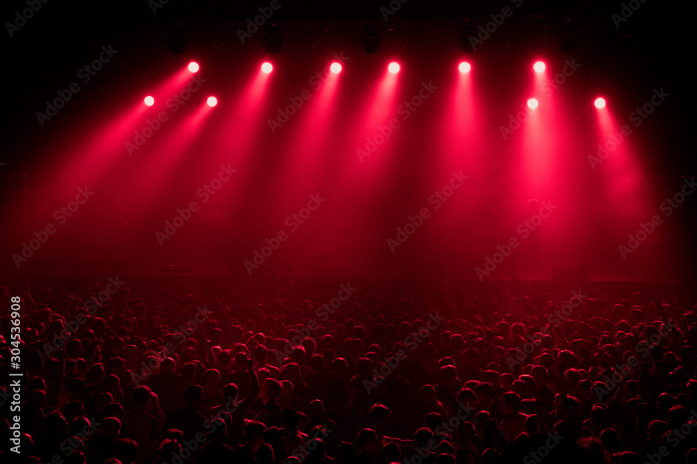 Red stage light with smoke in rock music concert. silhouettes of ...