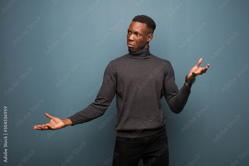 young african american black man shrugging with a dumb, crazy, confused ...