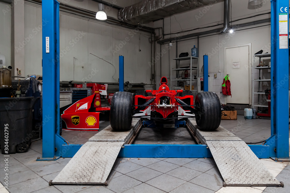 The process of repairing and restoring a red Ferrari Formula 1 car at a ...