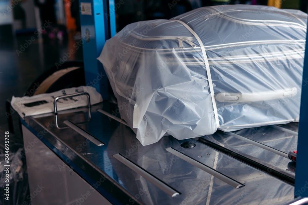 Luggage wrapping service at the airport terminal for security reason ...