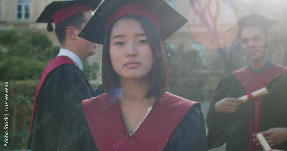 Close up of teh young Asian beautiful female graduate student in the ...