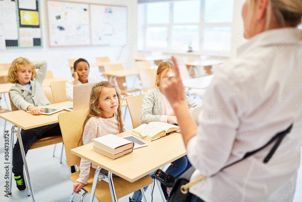 Teacher and student in class Stock Photo | Adobe Stock