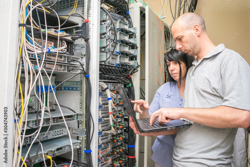 Experts look at the computer screen in the data center. System ...