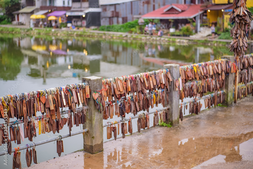 Kanchanaburi/Thailand-1 July 2017:Prayer tags tied on the bridge in the ...