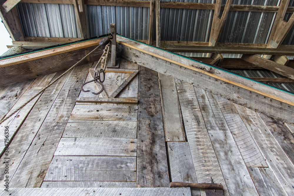 Exterior of barn and hayloft with hay carrier. Stock Photo | Adobe Stock