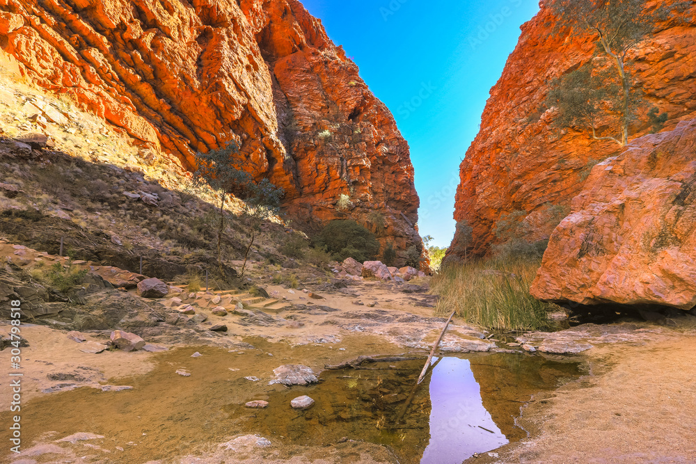 Simpsons Gap reflected in permanent waterhole in West MacDonnell ...