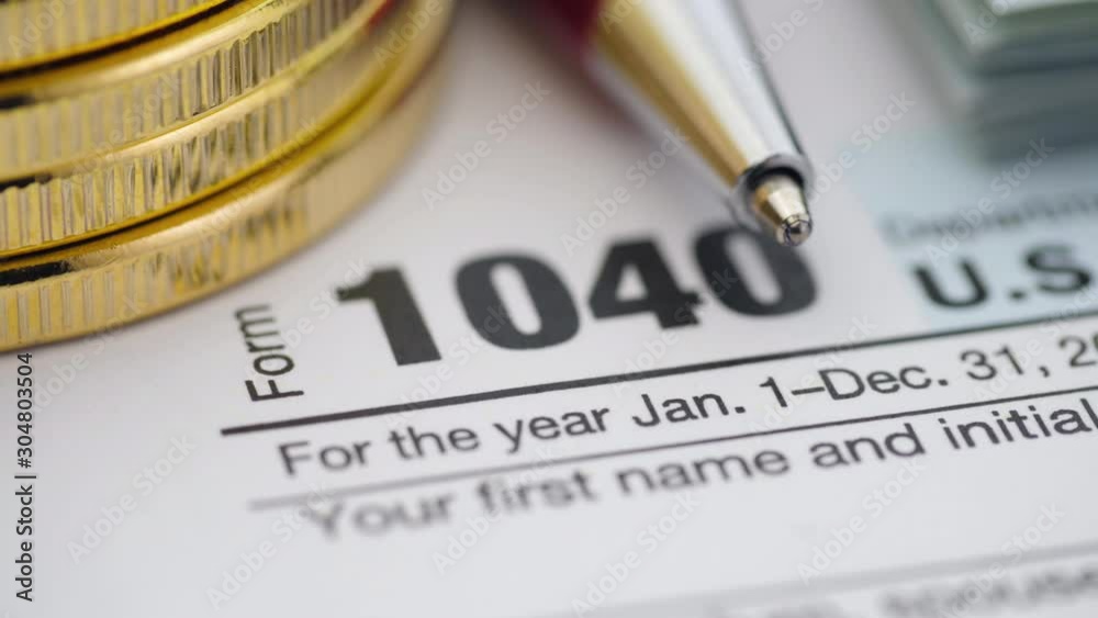 USA Tax Form 1040 and dollar bills, close up. Shallow depth of field ...