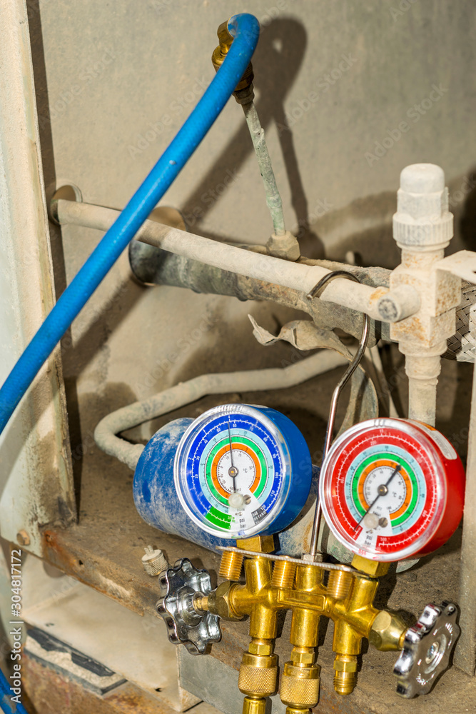 gas is being refiling into the heavy ac compressor of central air ...