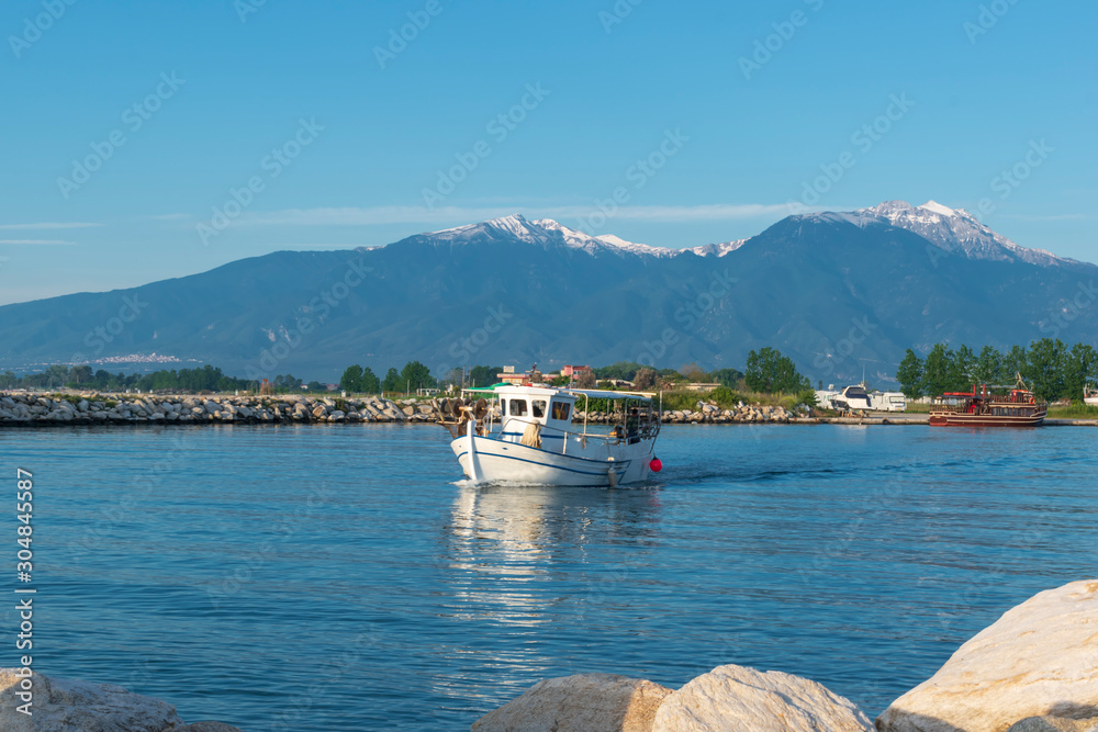Colorful bay with fishing boats and a view of Mount Olympus in the ...