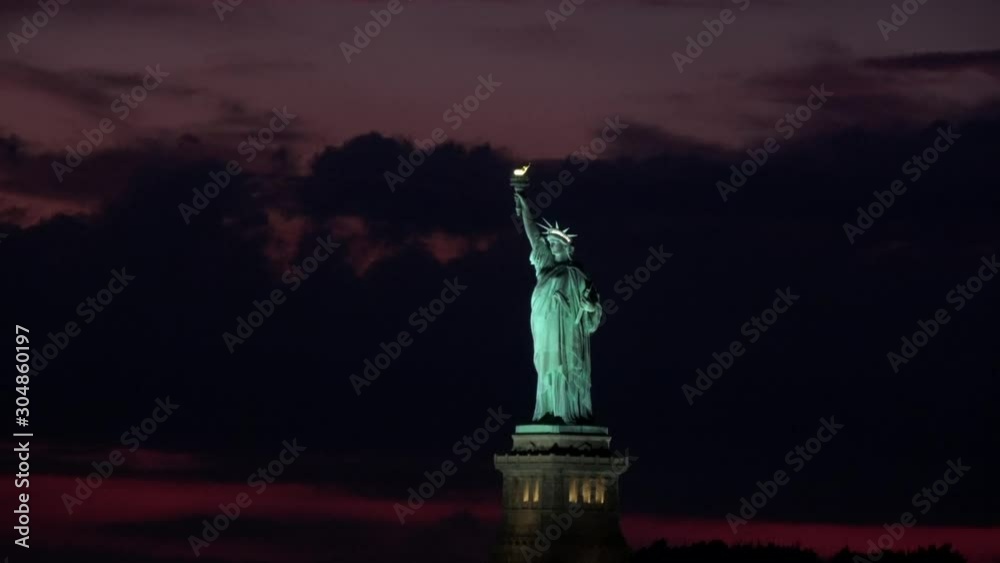 4K. Ultra HD. Zoom shot of the Statue of Liberty filmed at sunset from ...