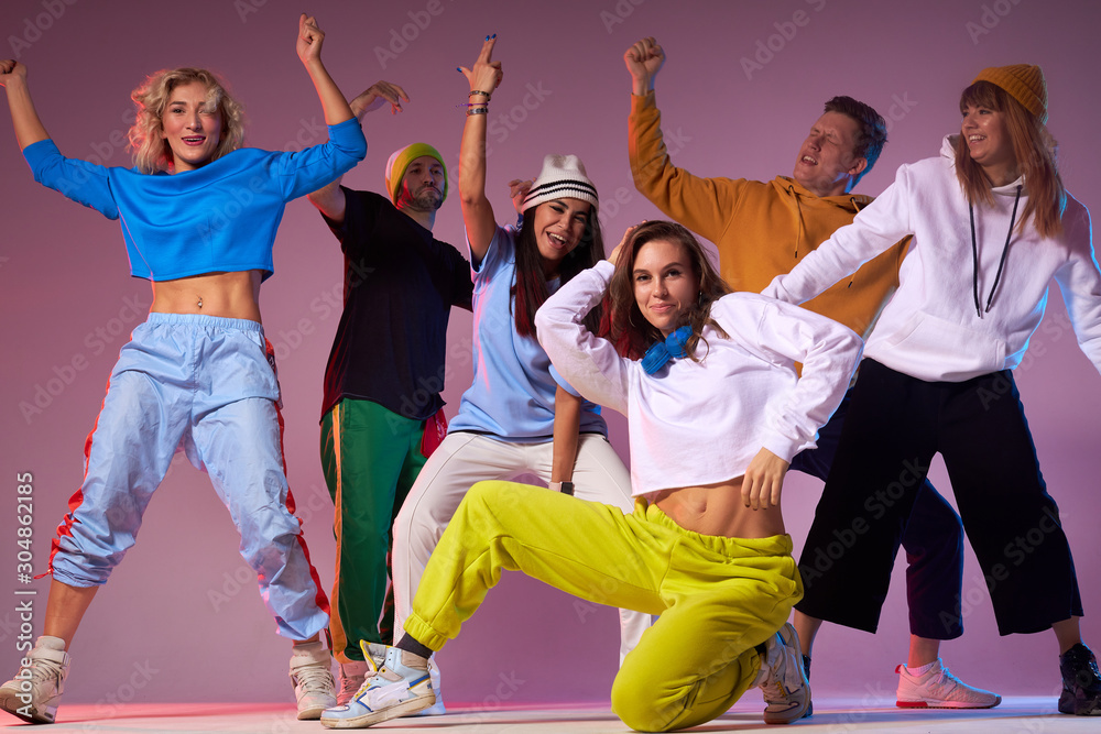 Young group of energetic teenagers dancing with soul, demonstrating ...