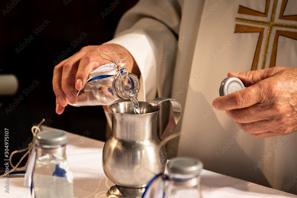 Holy water poured by a priest into a church Stock Photo | Adobe Stock
