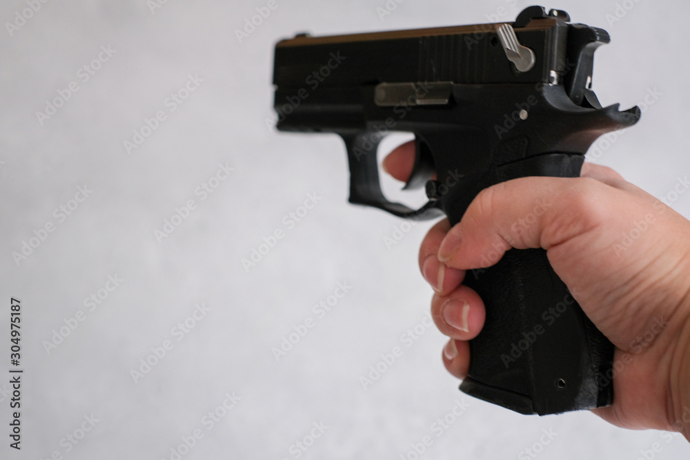 law enforcement aim pistol by the hand in academy shooting range in flare. a pistol 9mm, in the ...