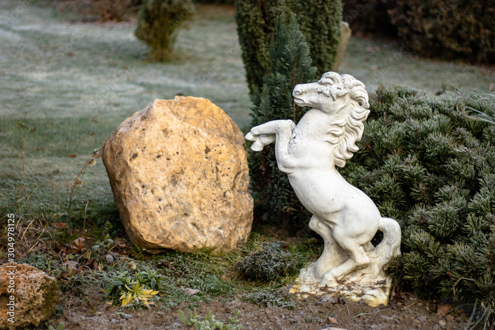 Decorative statue of a horse standing on the back legs in the garden ...
