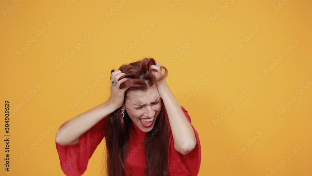 Red lady is shouting and crying. She is upset as something bad happened ...