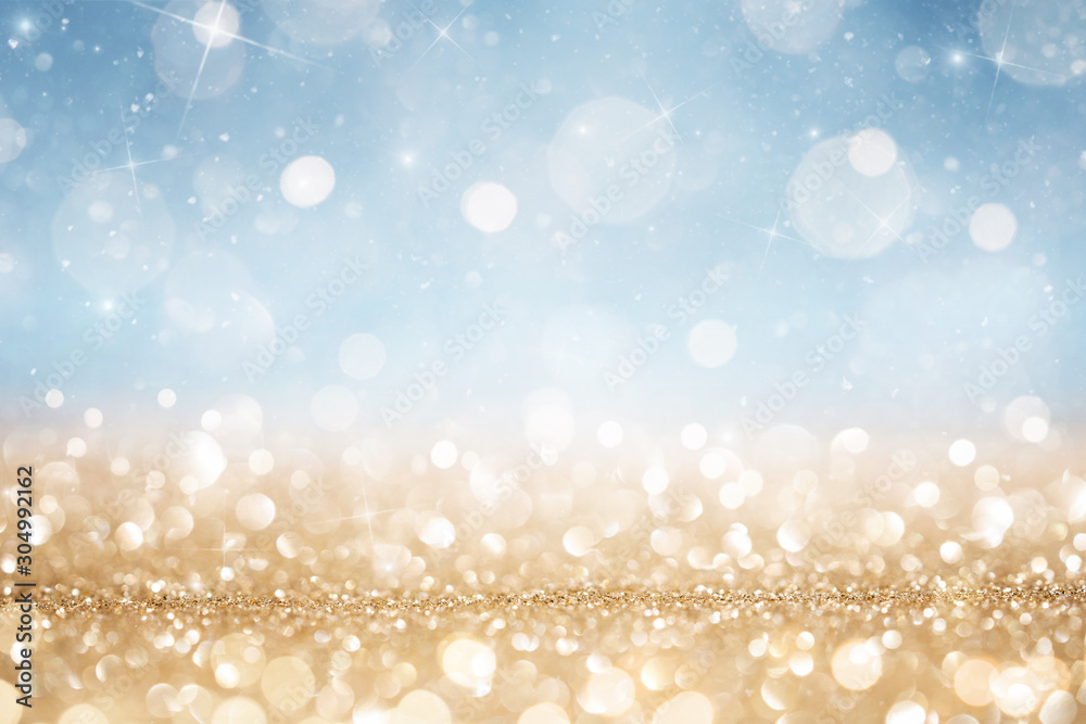 Abstract defocused gold and blue glitter background with copy space ...