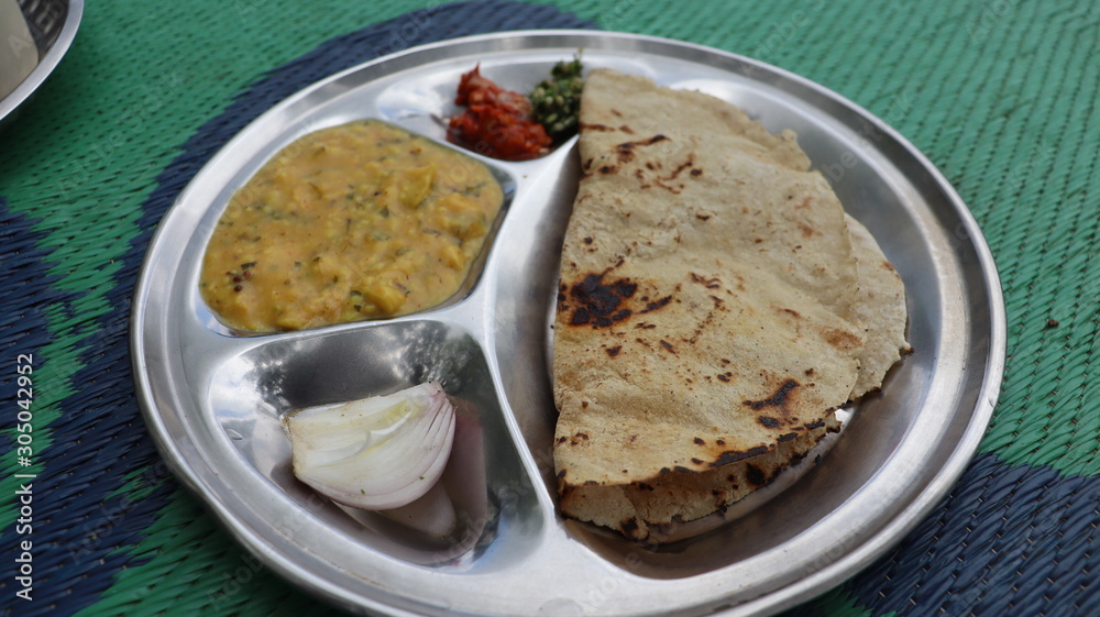 Traditional Maharastrian food served with curry. Stock Photo | Adobe Stock